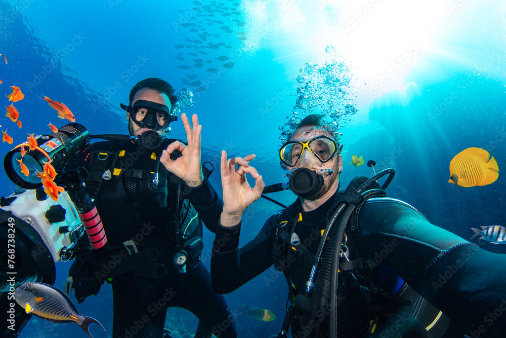 Scuba Divers Swimming in Deep Sea With Sunrays. Young Man DIver ...