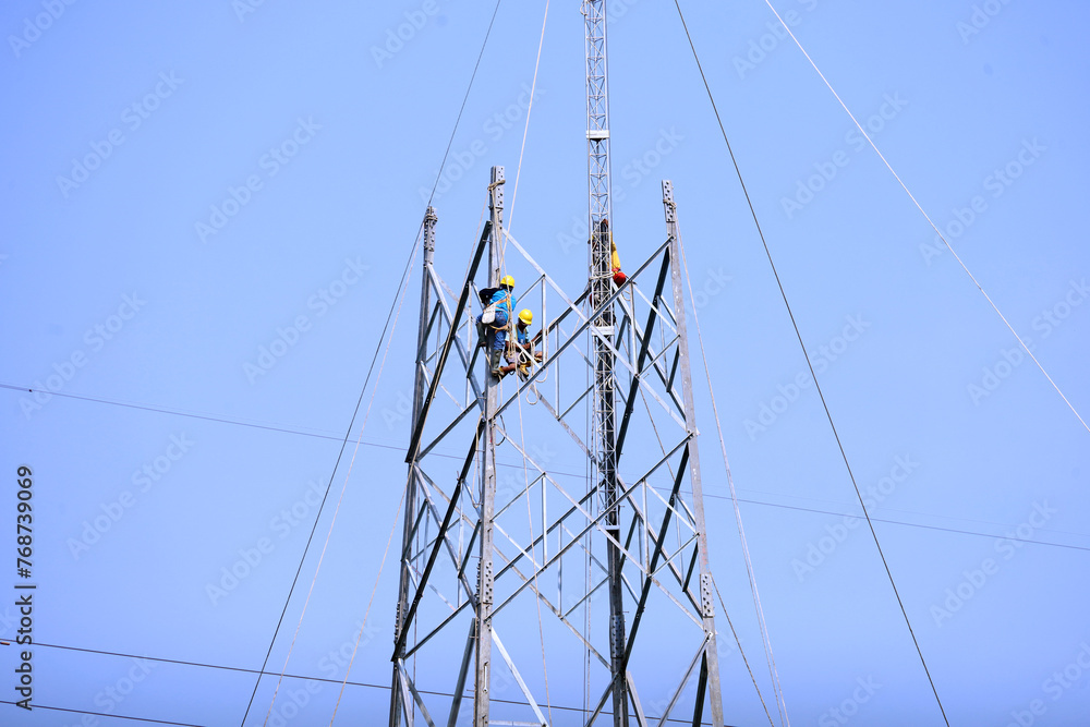 workers erecting towers, workers at heights, climbing towers with ...