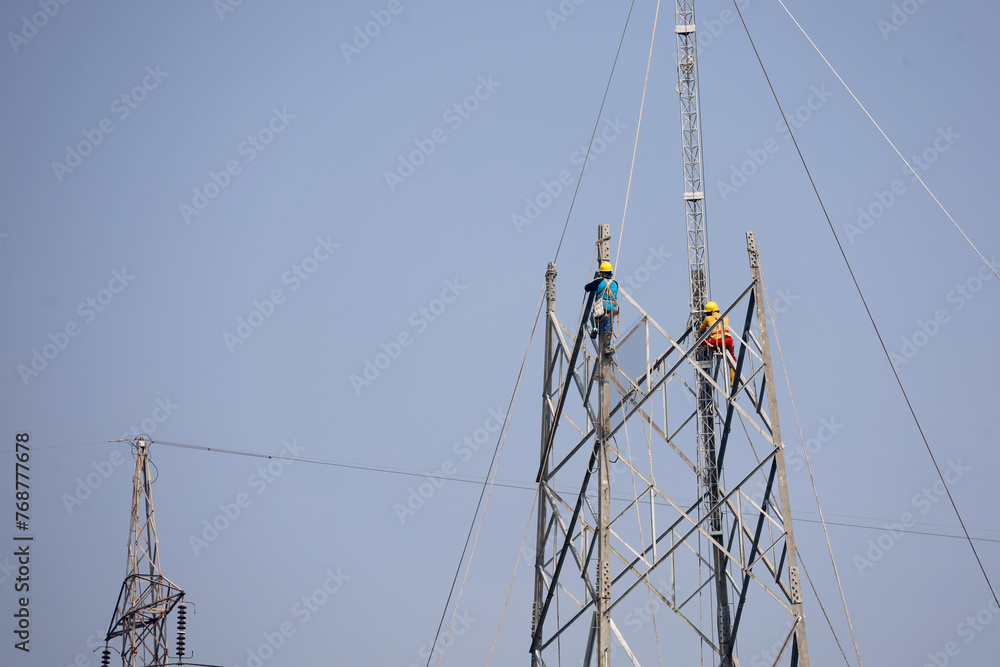 Poster workers erecting towers, workers at heights, climbing towers ...