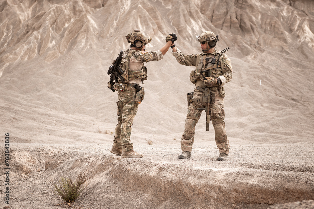 Soldiers in camouflage uniforms aiming with their rifles.ready to fire ...