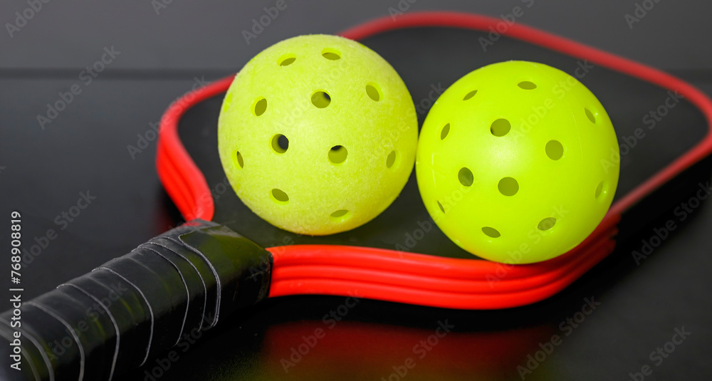 Pickleballs and Pickleball paddles. The sport of pickleball has become ...