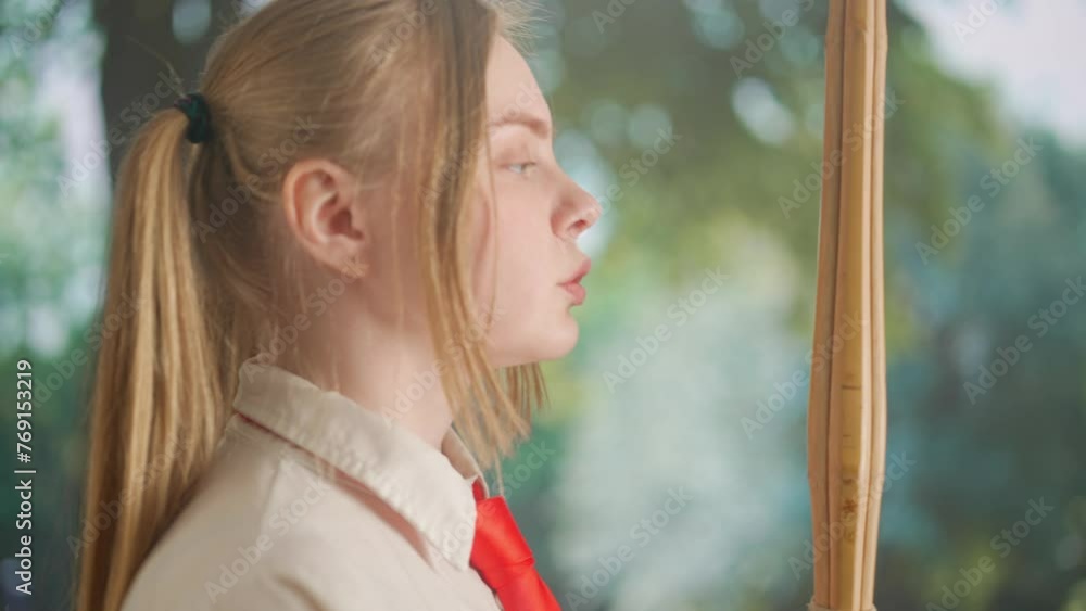 Person with sword posing at camera. Young woman in school uniform ...