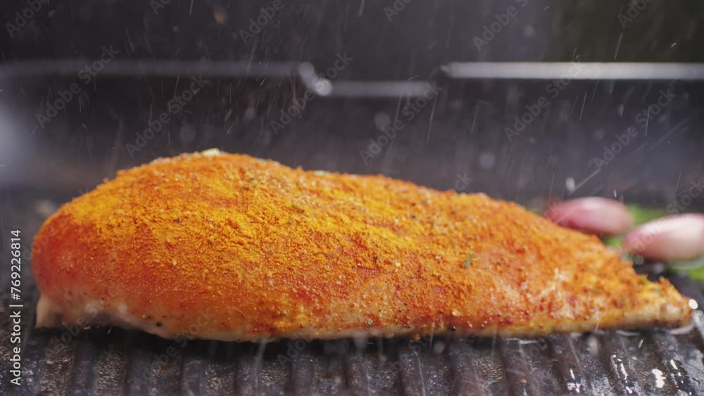 Cooking raw chicken meat in yellow turmeric spice with garlic and ...