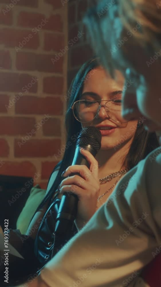 Vertical side footage of Caucasian female vocalist finishing singing ...