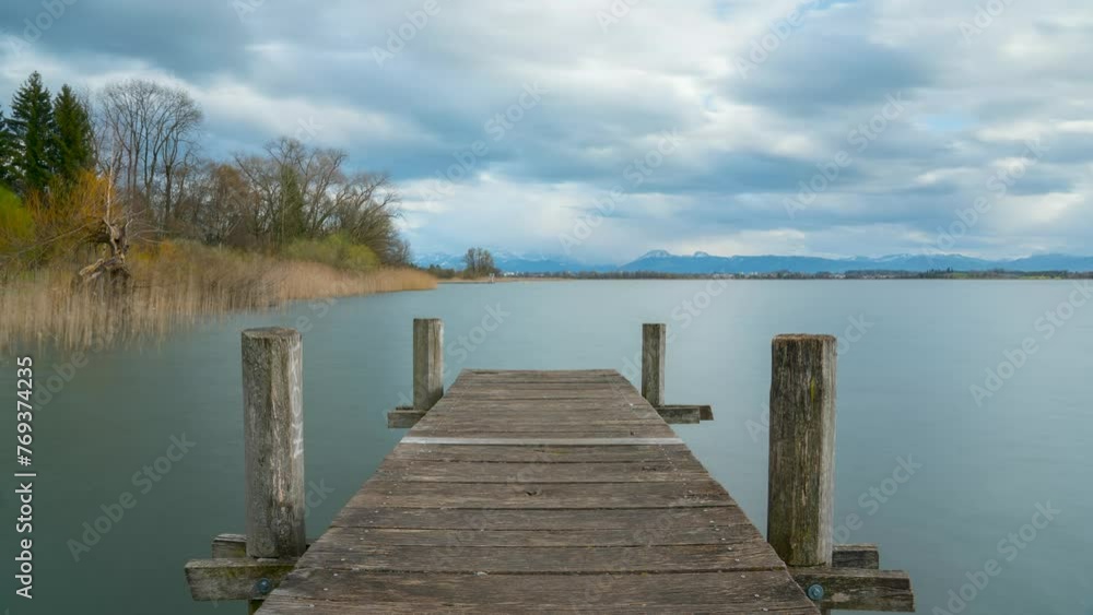 windy weather on a lake. The clouds move over the landscape. On the ...