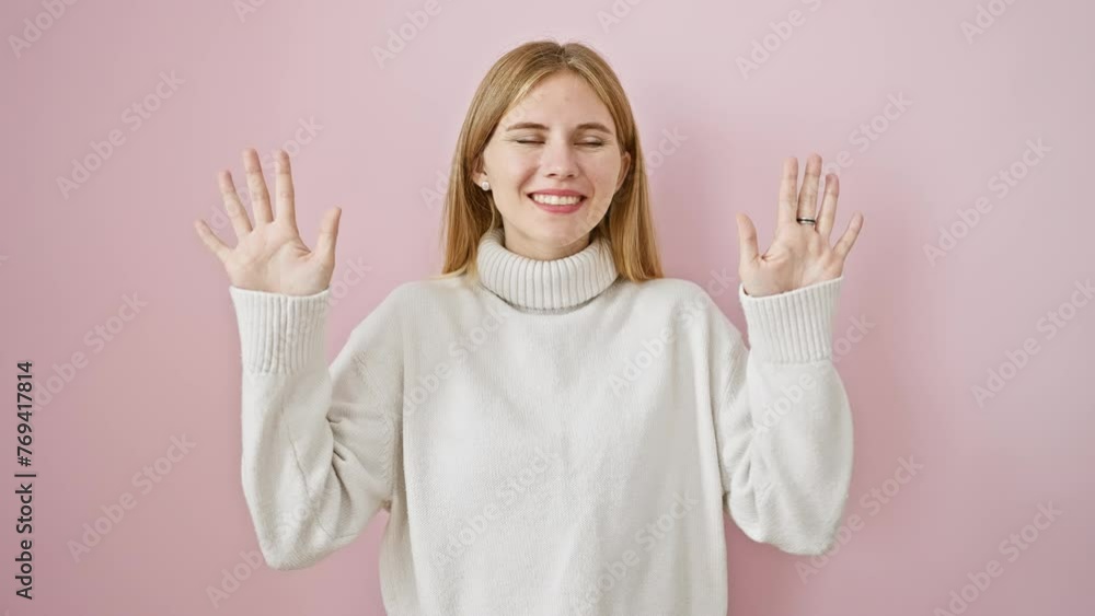 Happy blonde girl, caucusing her ten fingers, smiling and standing ...