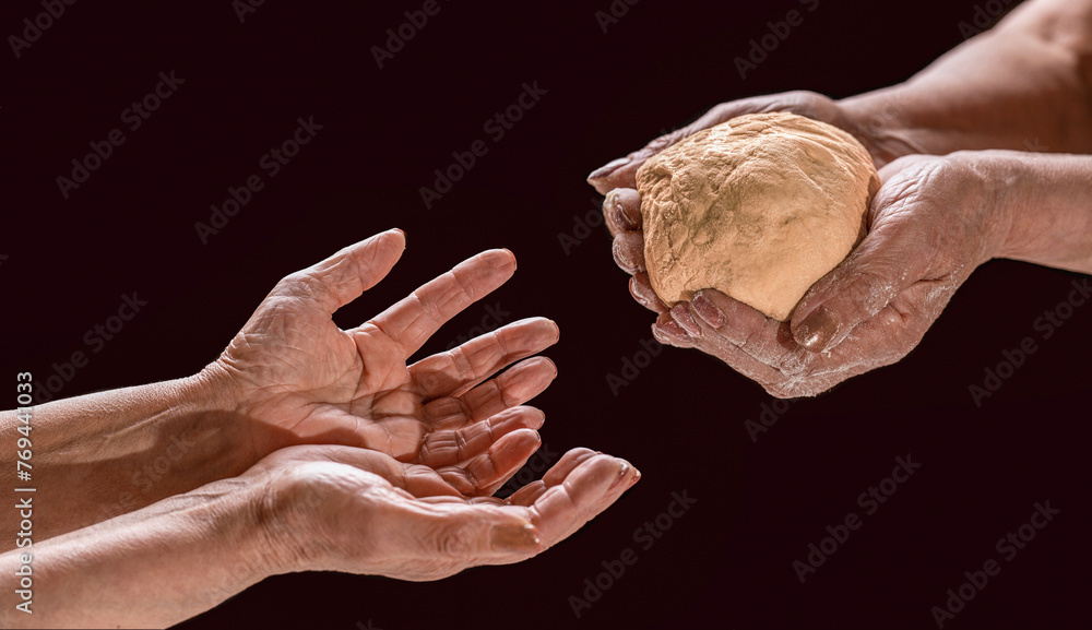 Helping the homeless. Woman giving poor homeless person pieces of bread ...