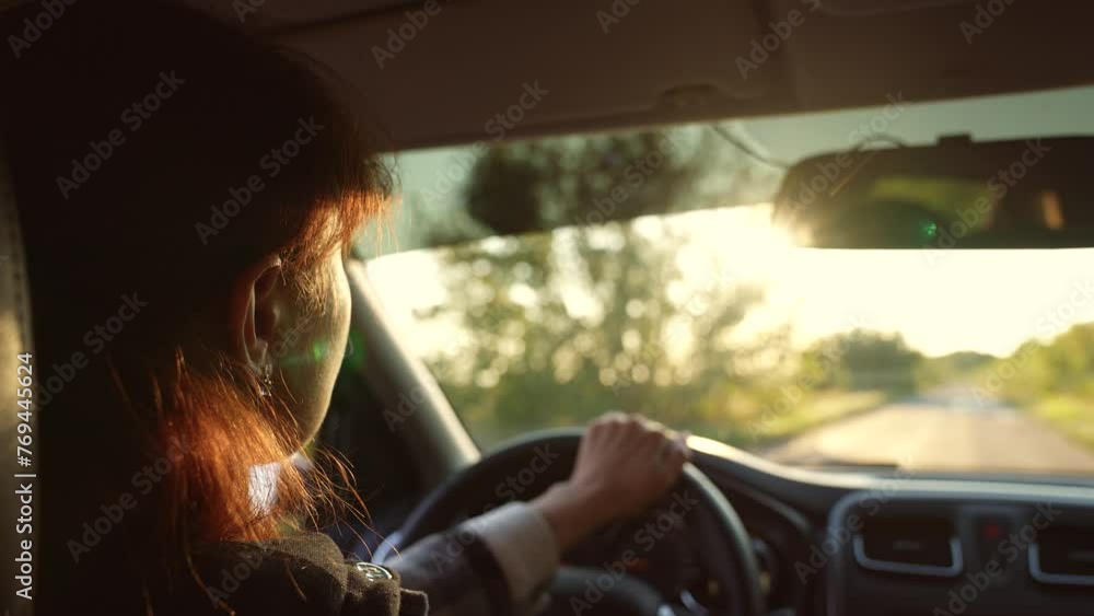 Redhead woman driver driving car at sunlight countryside rural summer ...
