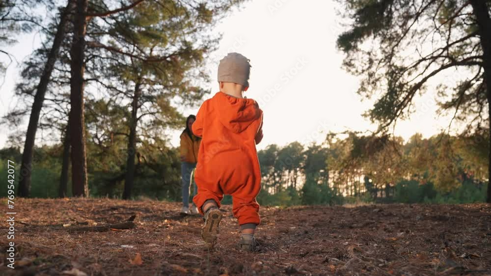 Happy family concept.child with mother in park at sunset.baby takes his ...