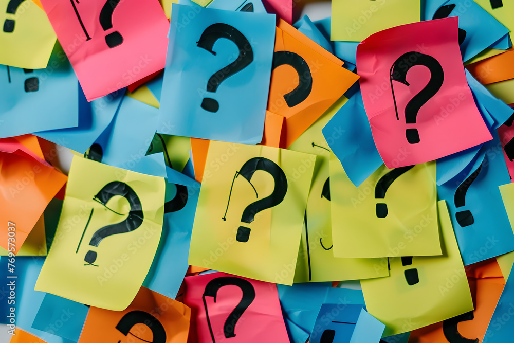a pile of colorful post - it notes with question marks on them and a ...