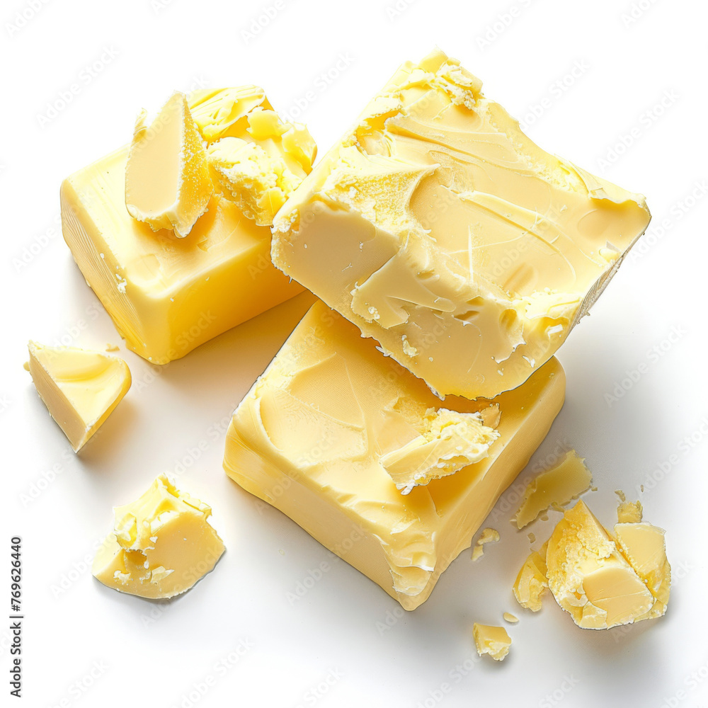 Freshly cut blocks of butter on a white background, depicting ...