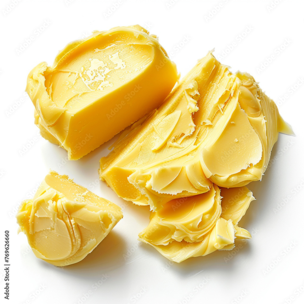 Freshly cut blocks of butter on a white background, depicting ...