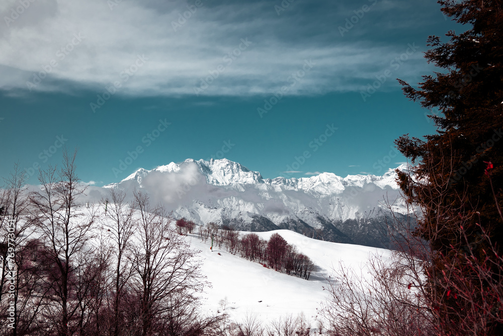 Monte rosa mountain, low clouds, blue sky. Suggestive view of Monte ...