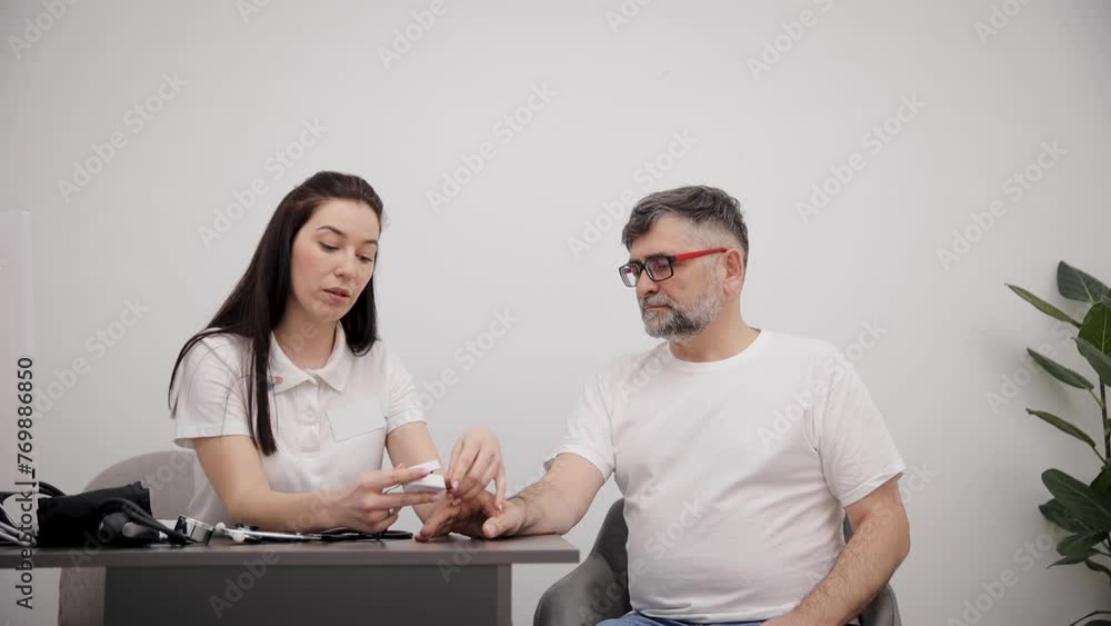 Nurse puts on finger heart rate monitor - pulse oximeter - showing ...