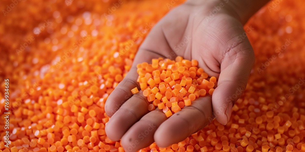 Hand Holding Orange Plastic Resin Pellets for Plastic Manufacturing ...