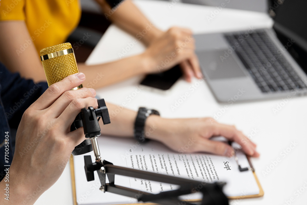 Selective focusing on hands with writing script note of radio ...