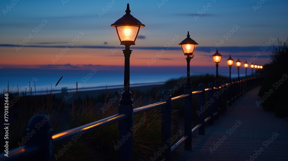 A beach promenade with solar powered street lights lining the way along ...