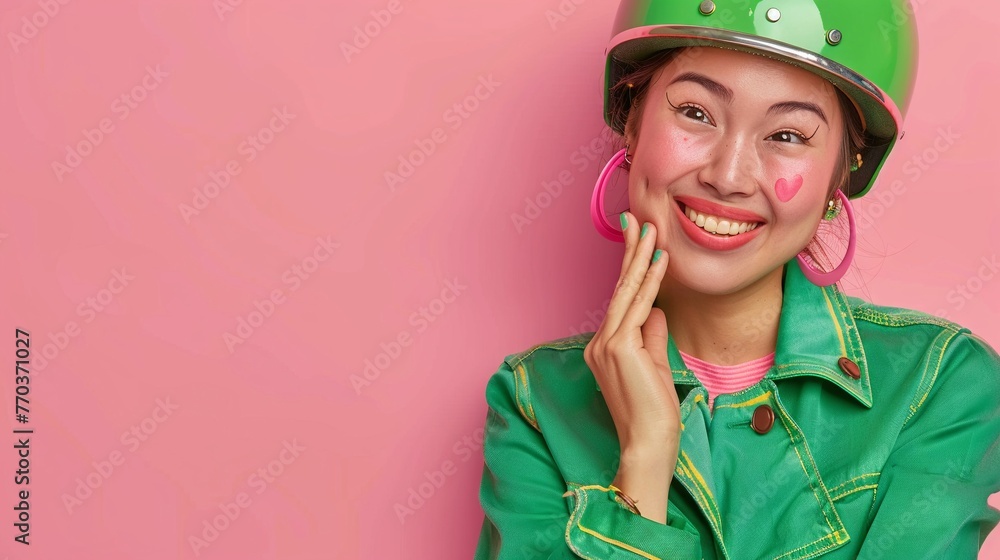 a smiling humble silly indonesian woman wearing emerald green helmet ...
