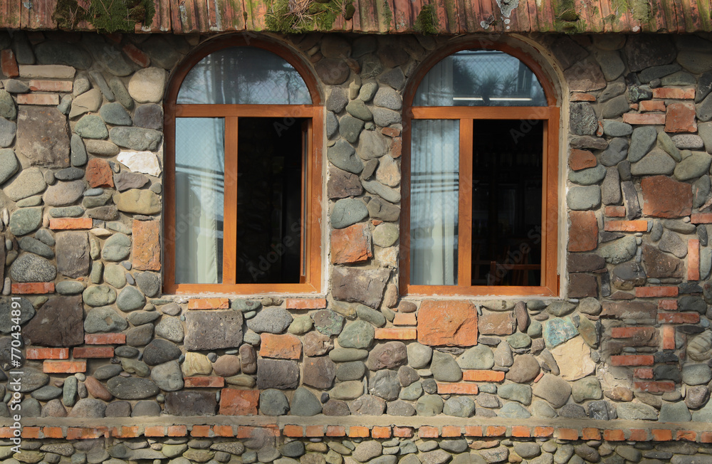 new, modern Wall of building made from cobble stone with 2 two arched ...