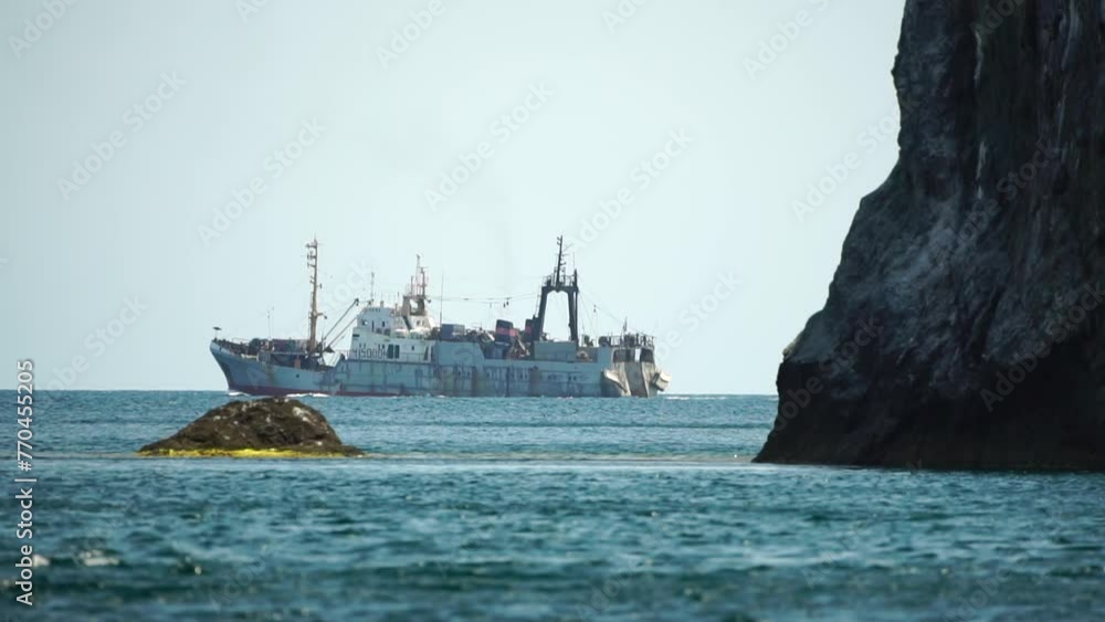 Fishing boat trawler catches fish while sailing on sea. A commercial ...
