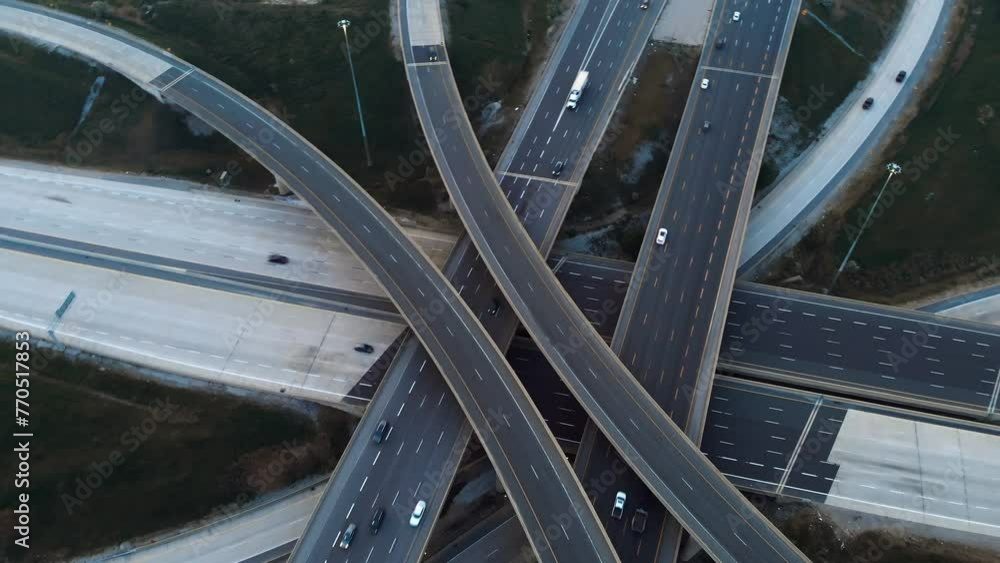 Cars driving along freeway go to exits from multi-level interchange ...