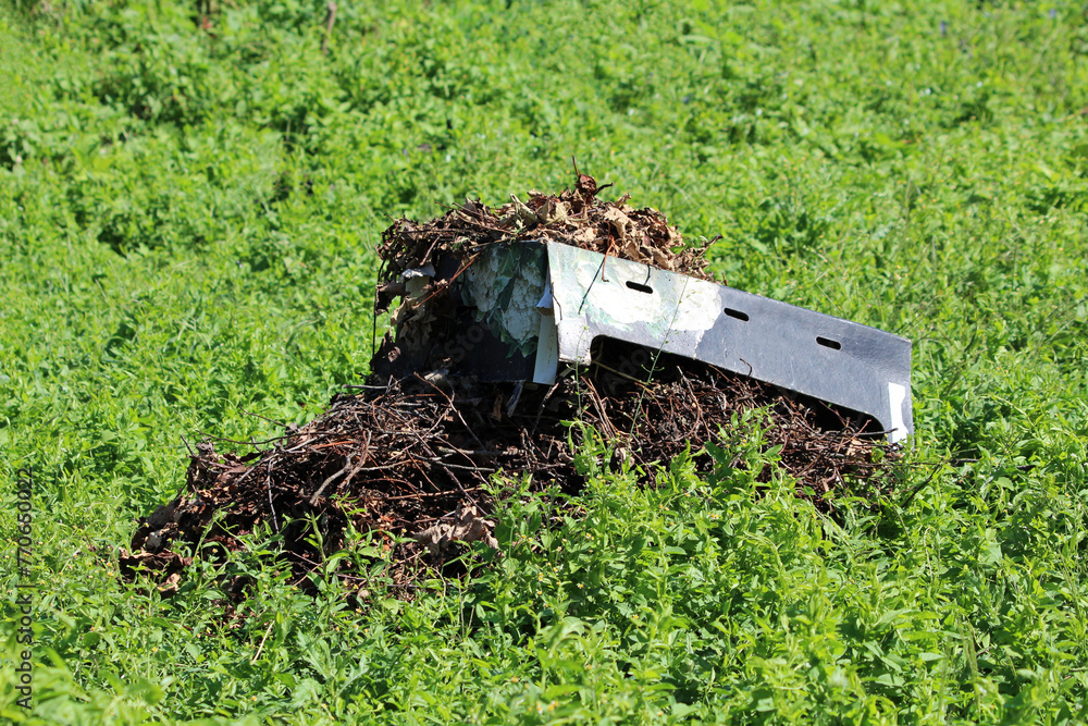 Homemade makeshift outdoor compost pile made of dry plants and small ...