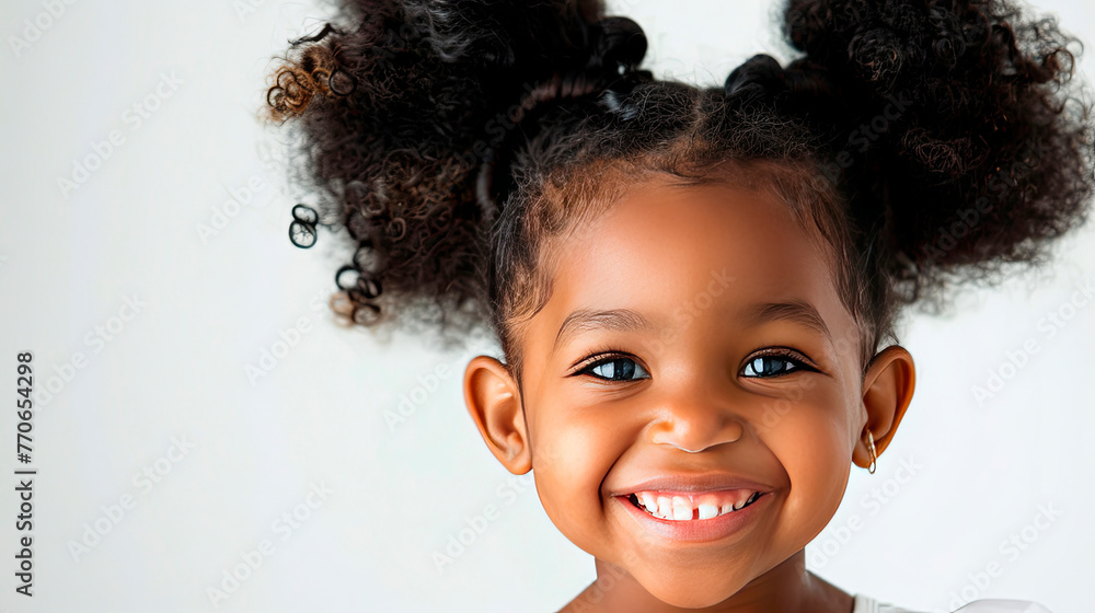 Bright-eyed young black girl with beautiful puffs smiling, ideal for ...
