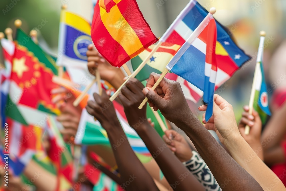 Foto de A diverse group of people holding flags from different ...