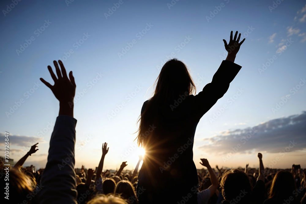 Silhouette of people watching and listening to a band at an open air ...
