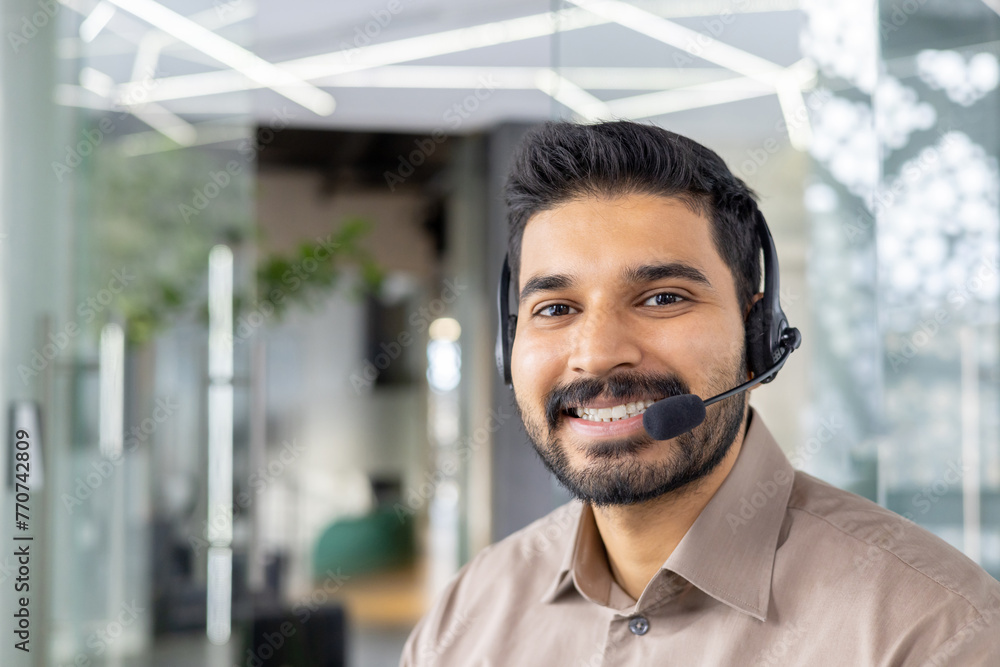 Professional male customer support representative wearing a headset in ...