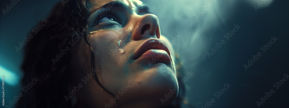 Young woman looking up praying to God with tears in eyes, being touched ...