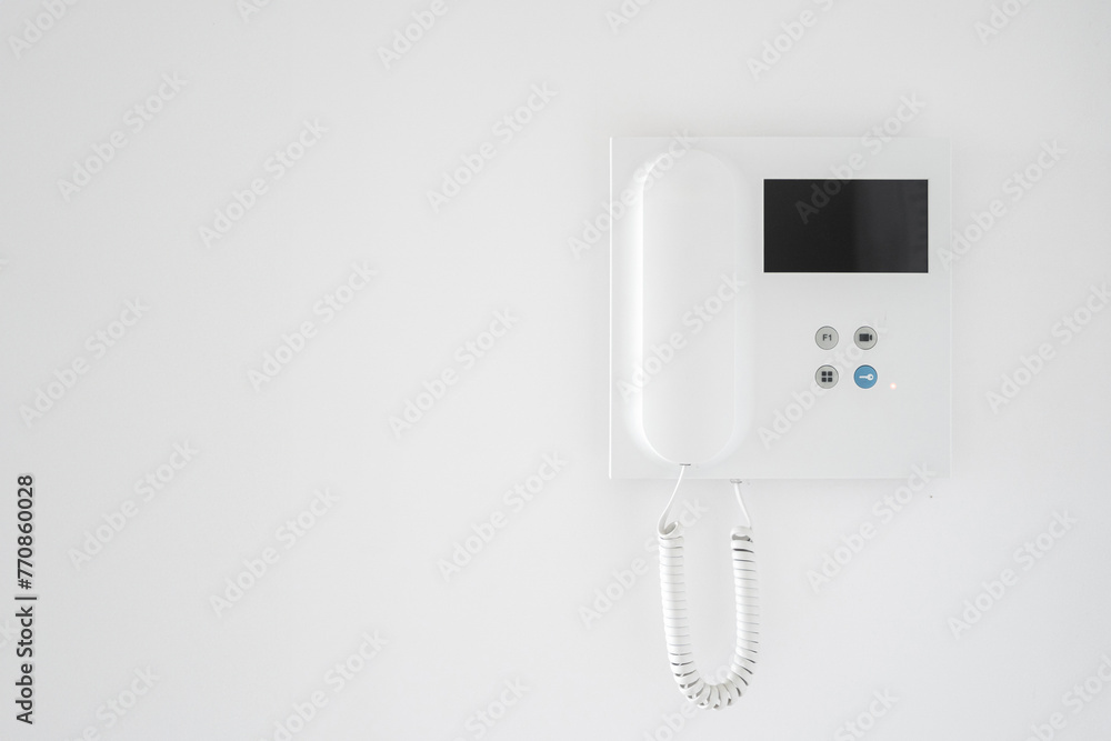 Poster Modern intercom system with handset on white wall background in ...