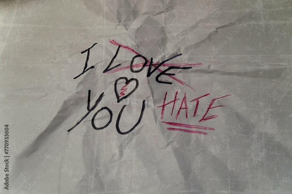 crumpled sheet of paper, with the writing, "I love you", crossed out ...