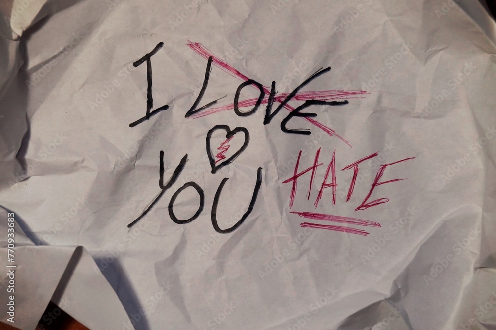 crumpled sheet of paper, with the writing, "I love you", crossed out ...