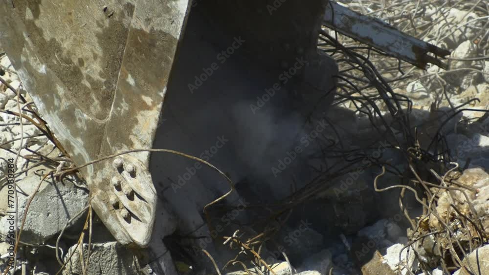 An excavator breaks up the concrete footings and scraps the ground of ...
