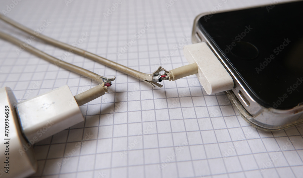 Fraying mobile charger cable. Extremely worn electrical wires. Broken ...