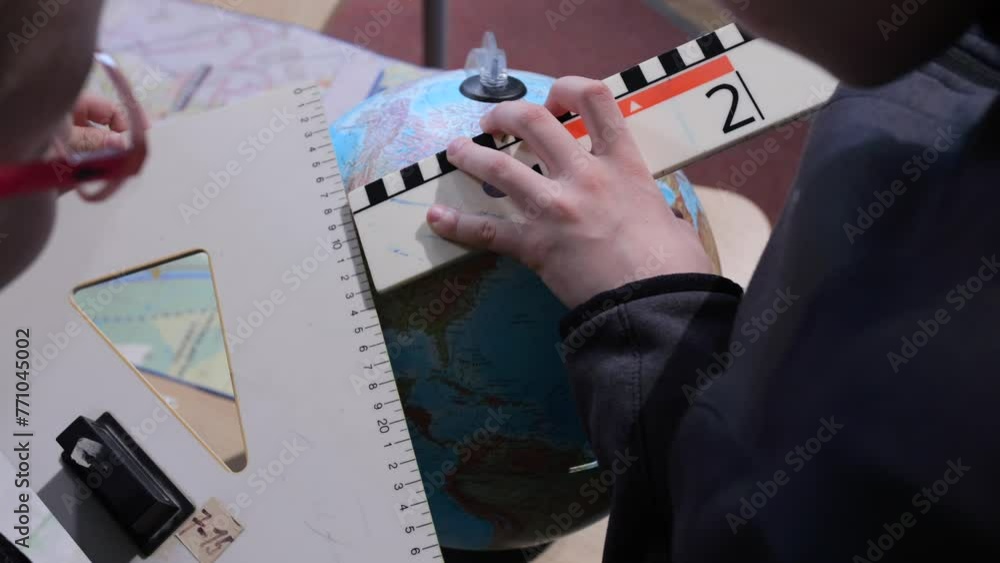 Student Hands Using a Clapperboard and a Globe for Geography Lesson ...
