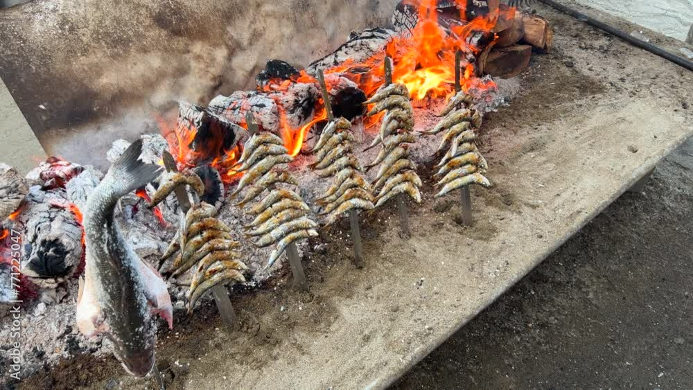 Traditional Spanish sardines Espetos fish grilled at the beach over ...