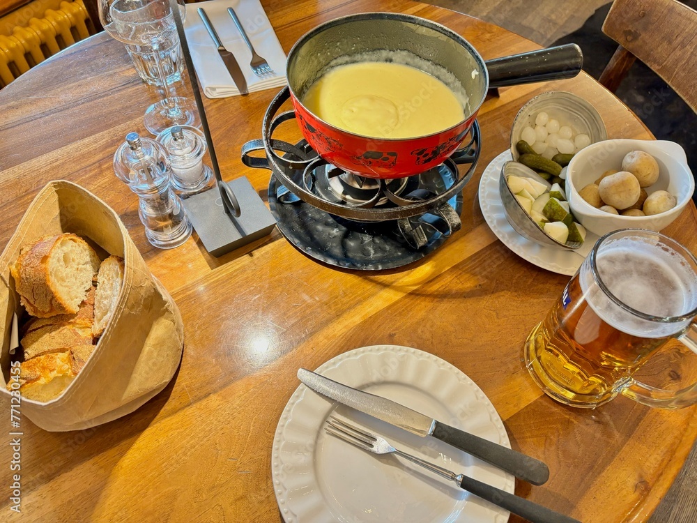 Typical Swiss cheese fondue as served in a traditional restaurant in ...