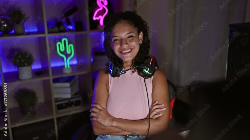 Attractive young hispanic woman streamer, flashing a smile, arms ...