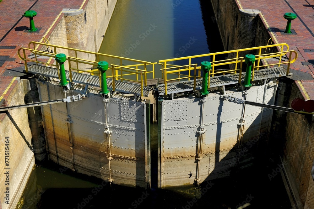 Lock gates of the water dam in river. Dam on river Nogat in Biala Gora ...