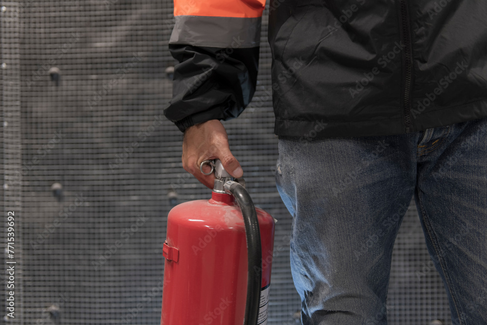 man with extinguisher on fire. person with extinguisher. Engineer ...