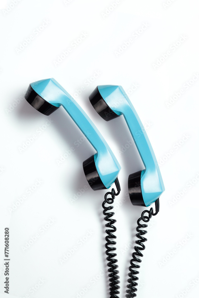 Pair of hanging telephone receivers. Aqua color telephone receivers ...