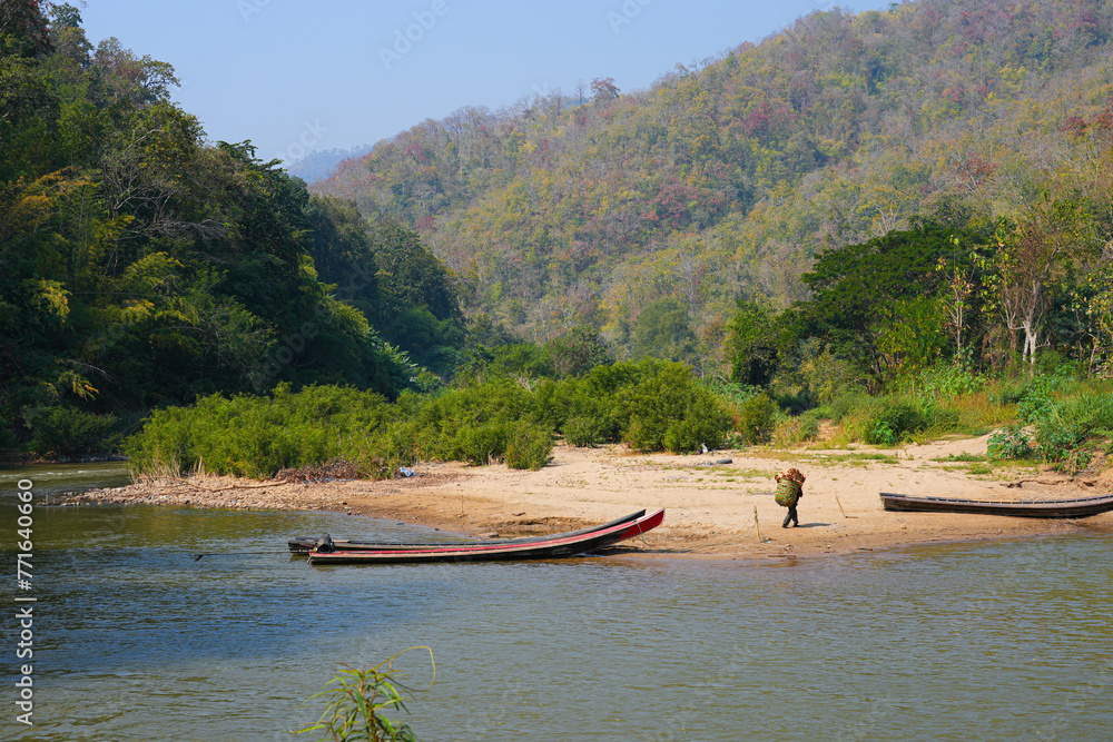 Longtail boats on the Pai River crossing towards the Huay Pu Keng long ...