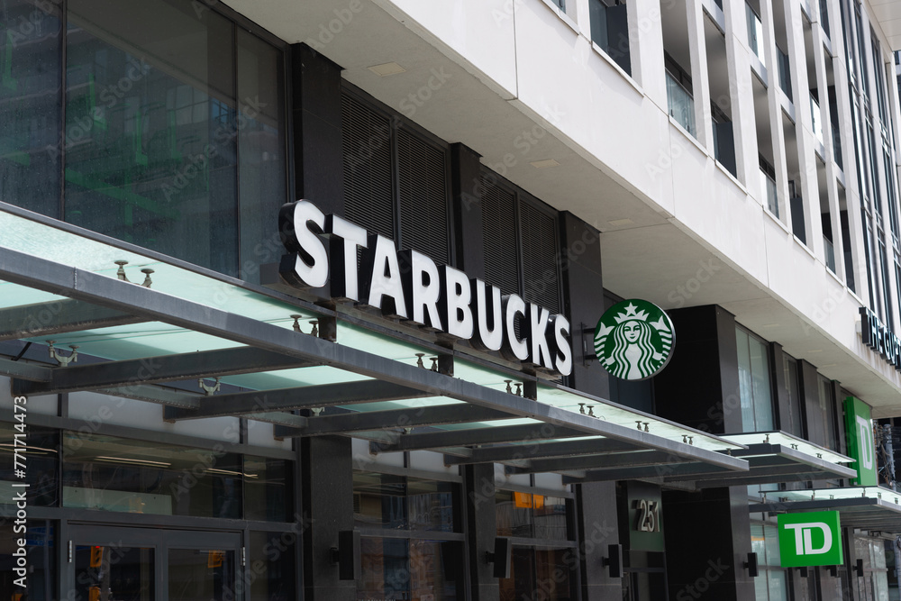 exterior building facade and sign of Starbucks, a coffee shop chain ...