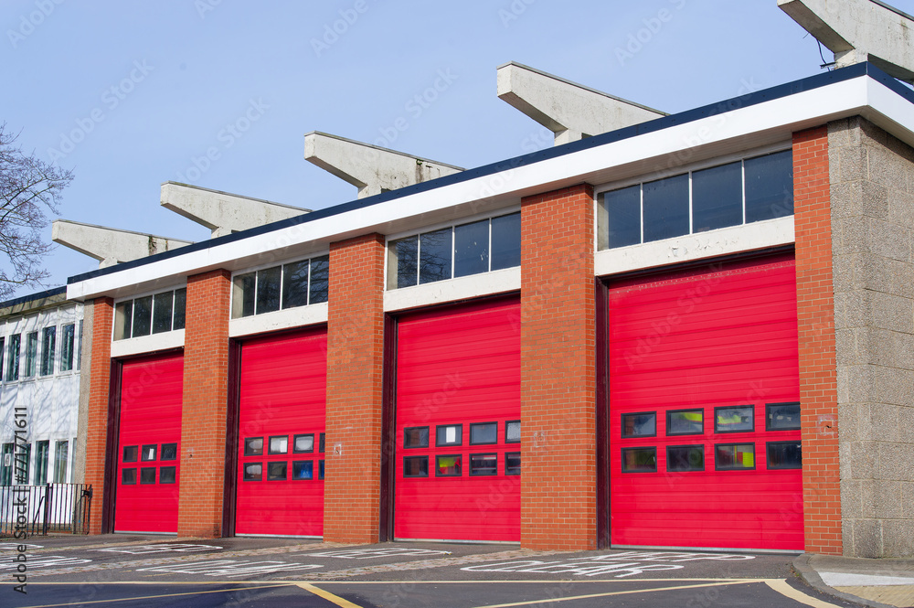 Fire brigade station building with red roller shutter doors Stock Photo ...