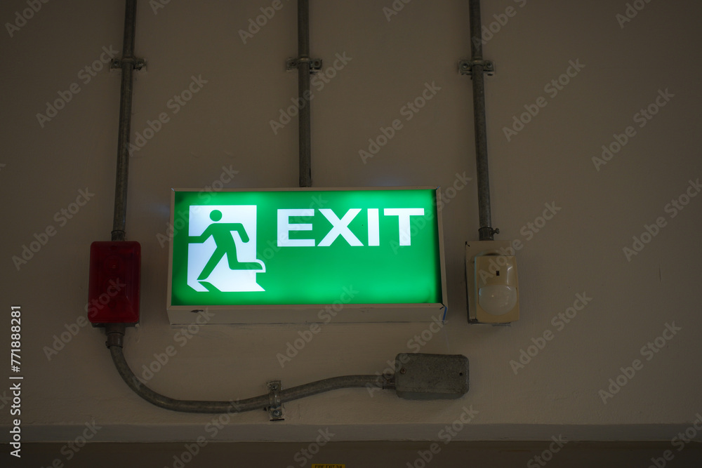 Exit Sign banner with lighting on the wall over walkway in building ...