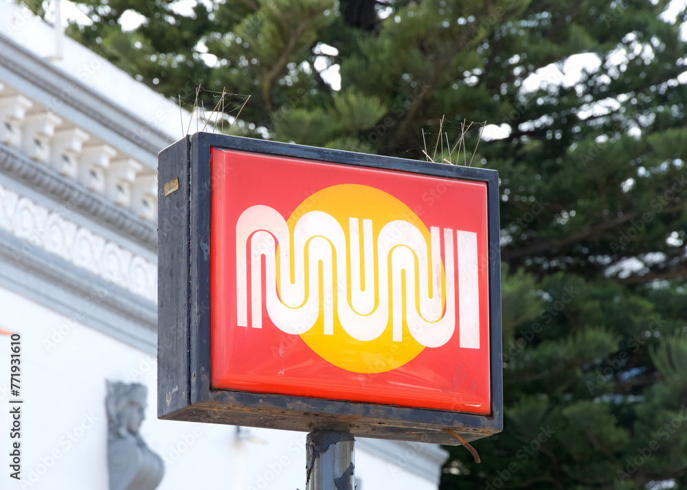 San Francisco, CA - March 30, 2024: Close up on Muni sign with building ...