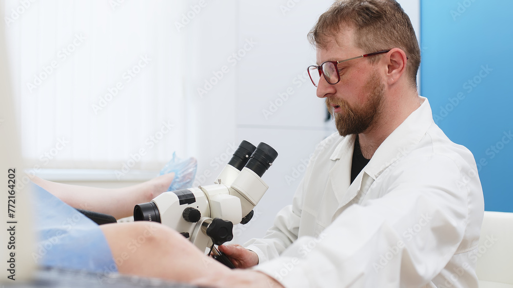 Gynecological office in a modern hospital. The gynecologist uses a ...