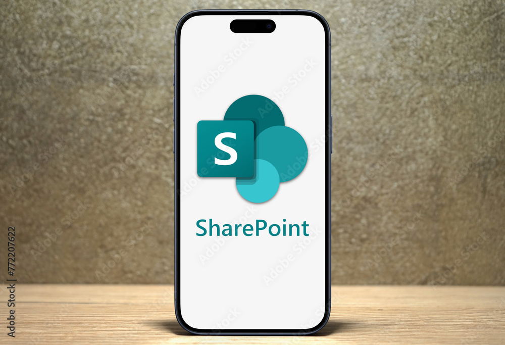 Microsoft Sharepoint logo is displayed on a modern smartphone standing ...